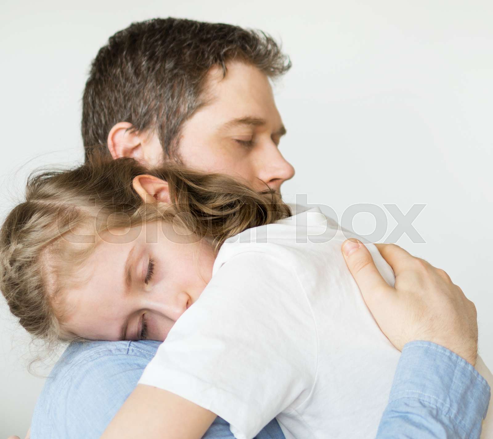 Sad little girl hugging her dad. | Stock image | Colourbox