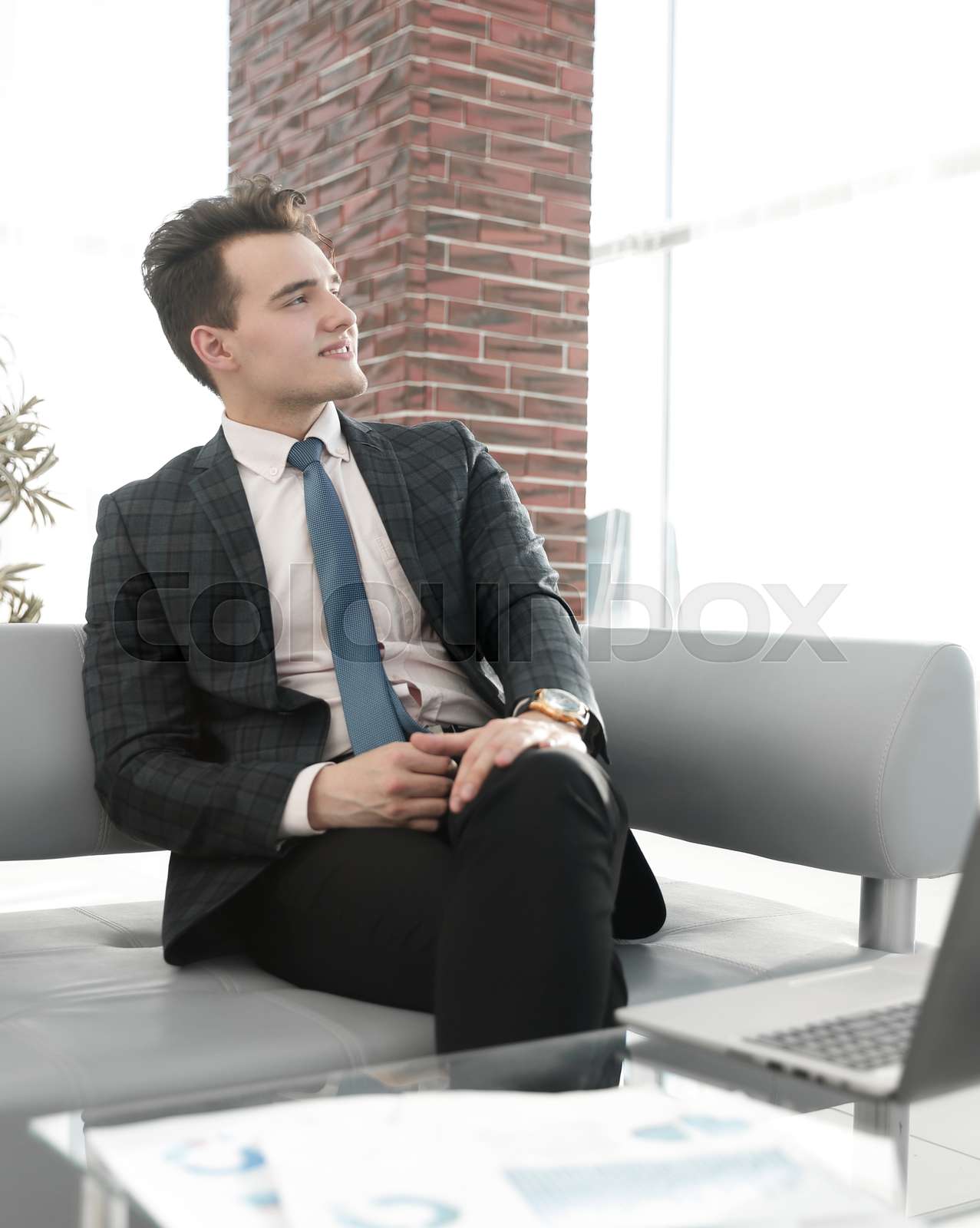successful businessman sitting on office sofa | Stock image | Colourbox