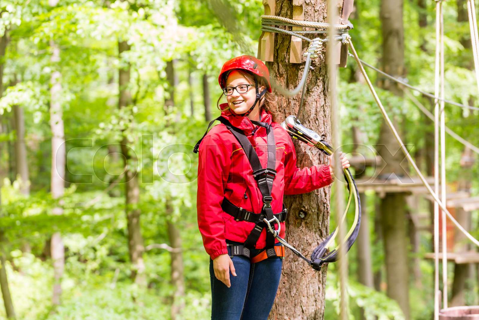 Child reaching platform climbing in high rope course | Stock image ...