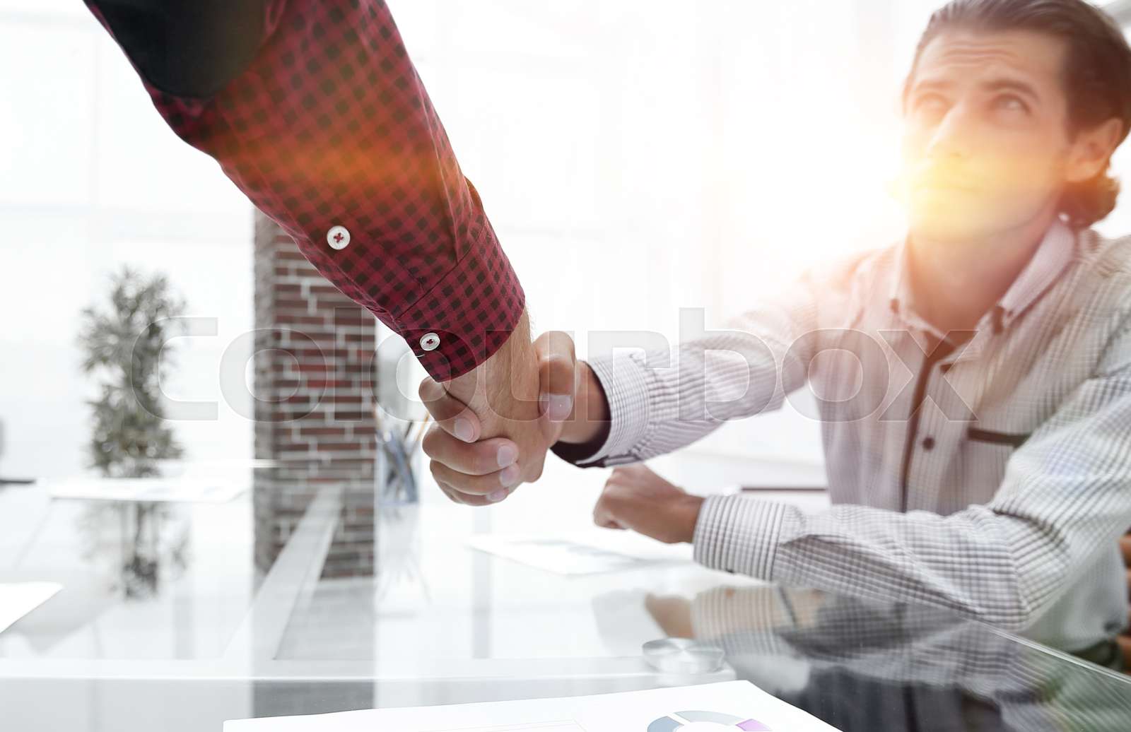 colleagues shaking hands over Desk | Stock image | Colourbox