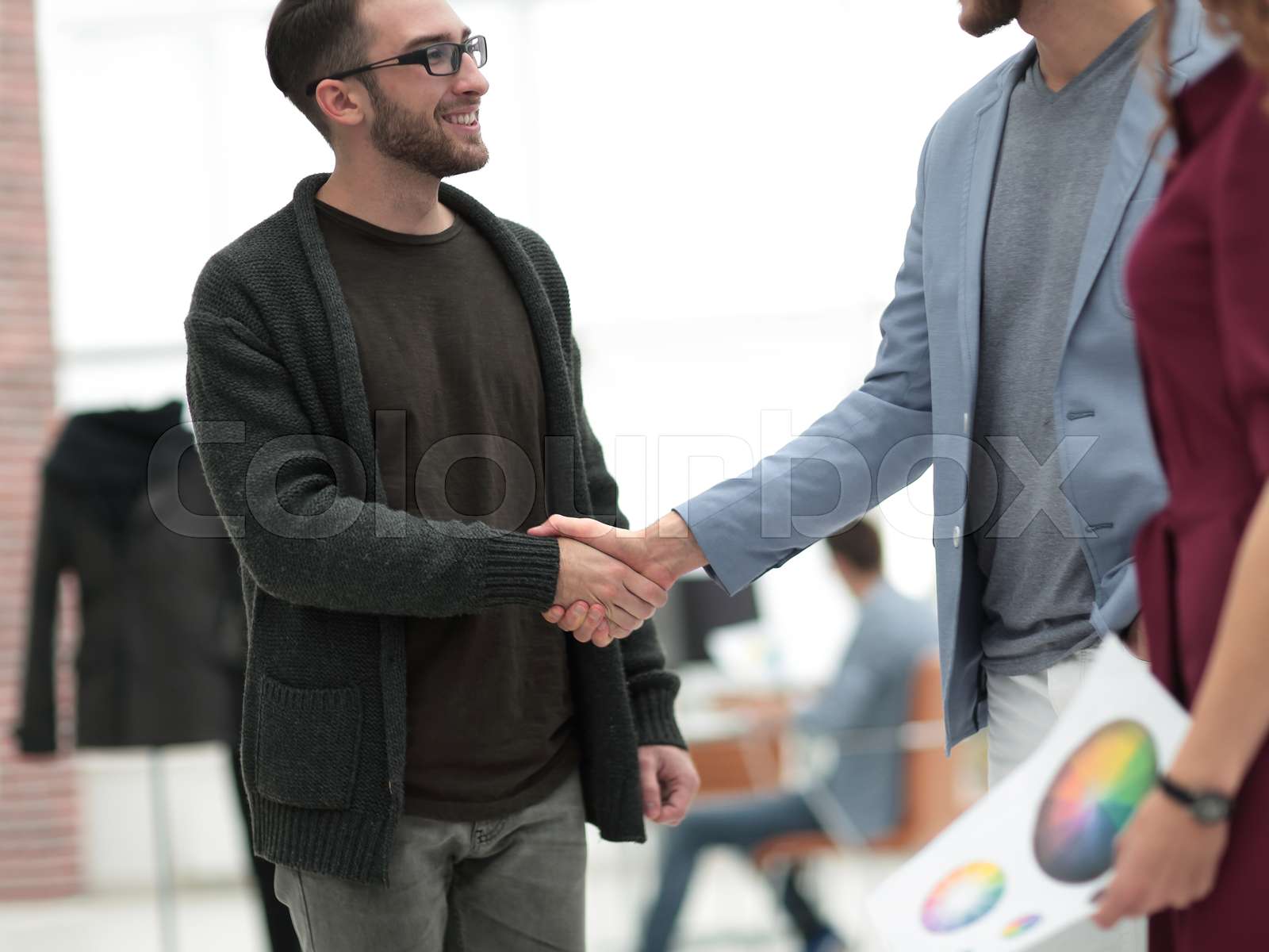 closeup.the handshake between the designer and the client | Stock image ...