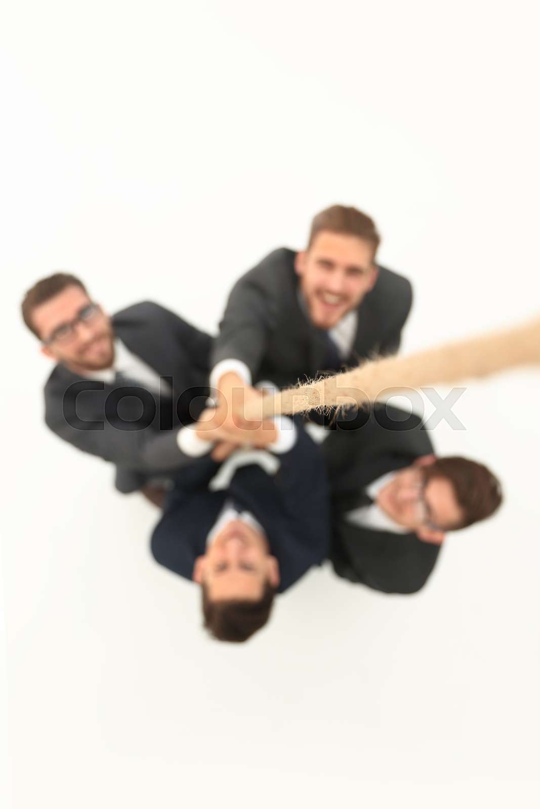 smiling business team holding the rope | Stock image | Colourbox