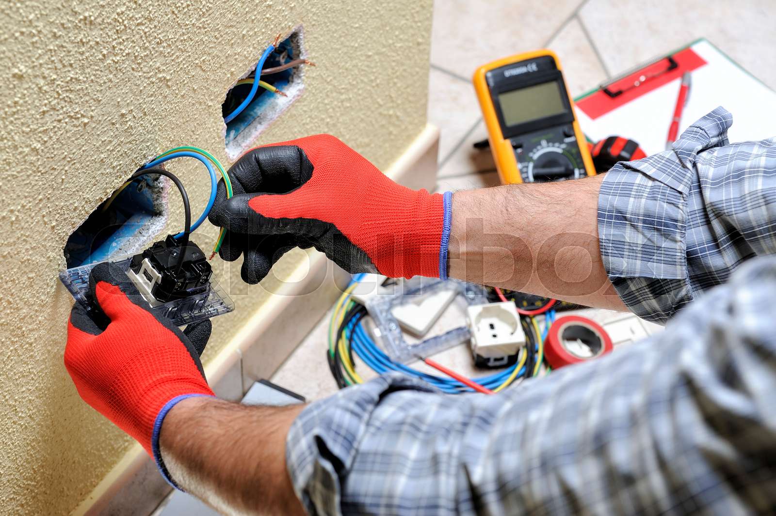 Electrician technician at work with safety equipment on a residential ...