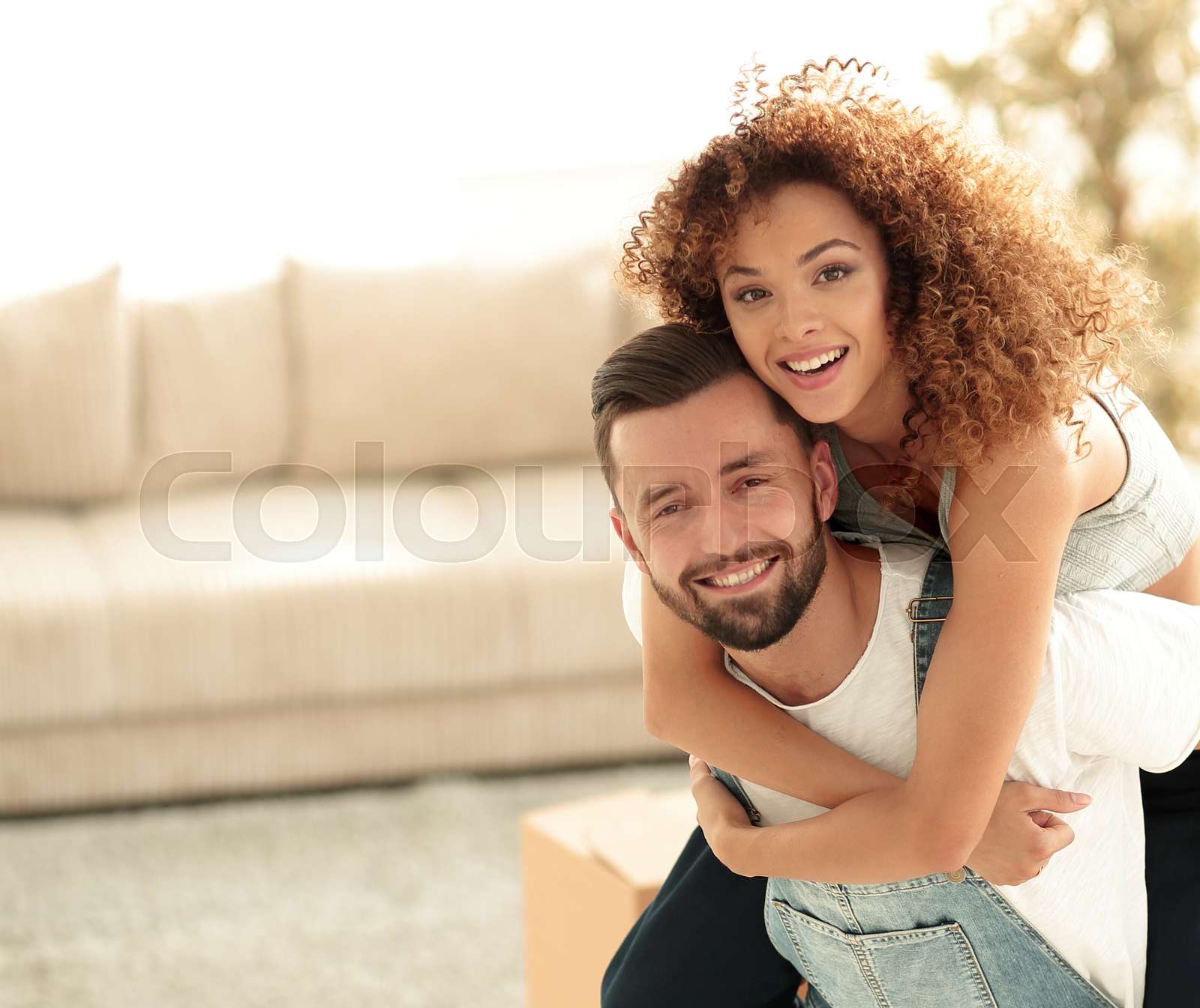 Happy family couple embracing in a new house | Stock image | Colourbox