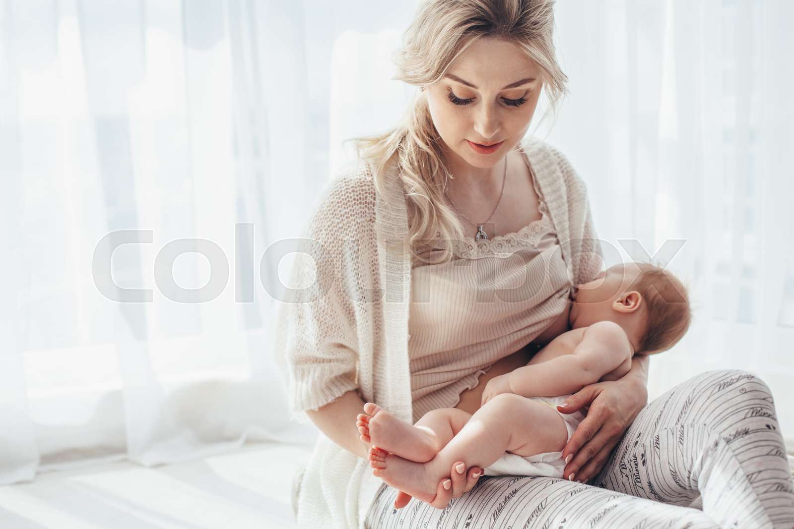 Mom breast feeding baby | Stock image | Colourbox