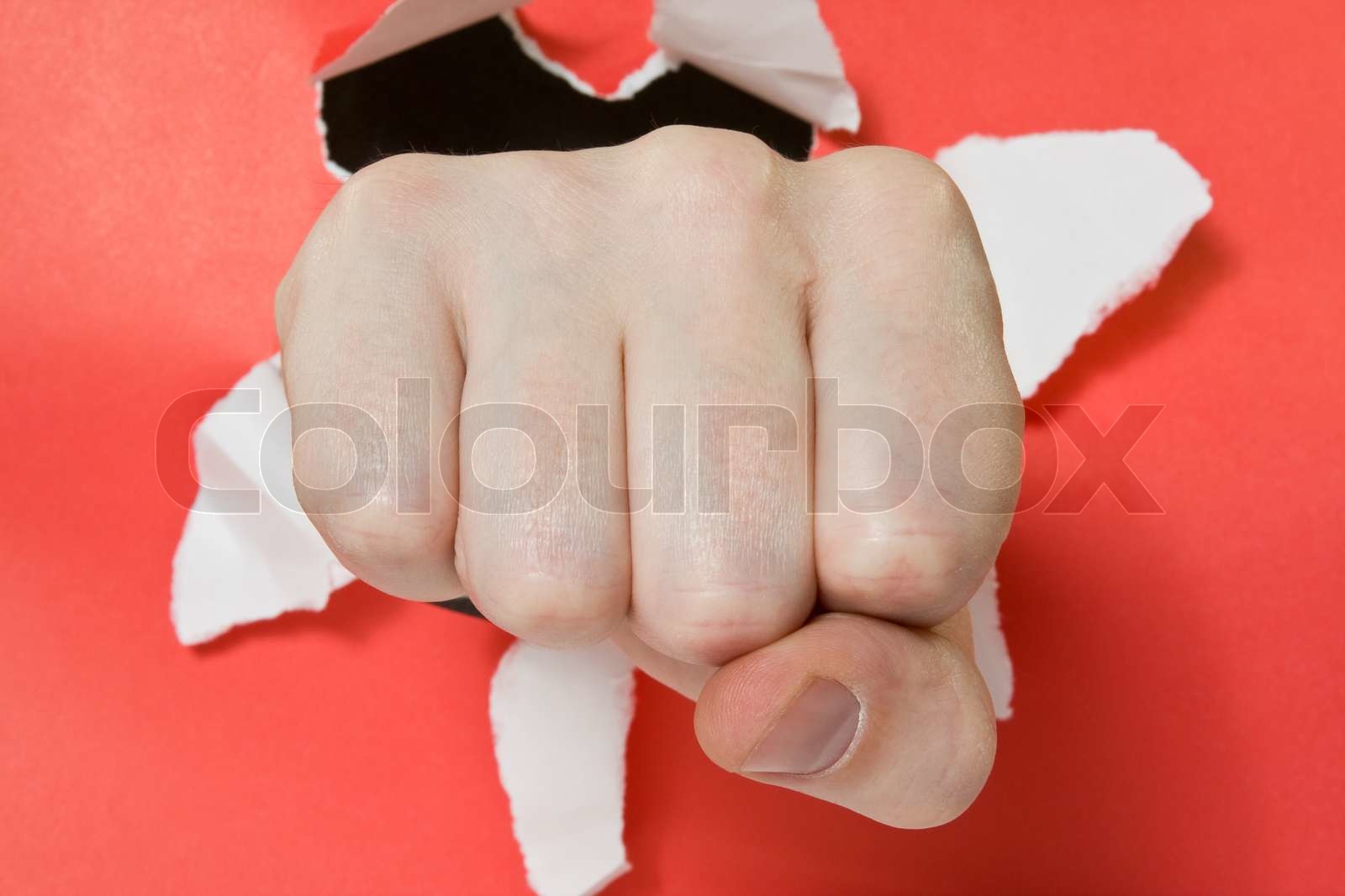 aggression and violence Hand punching through red paper | Stock image ...