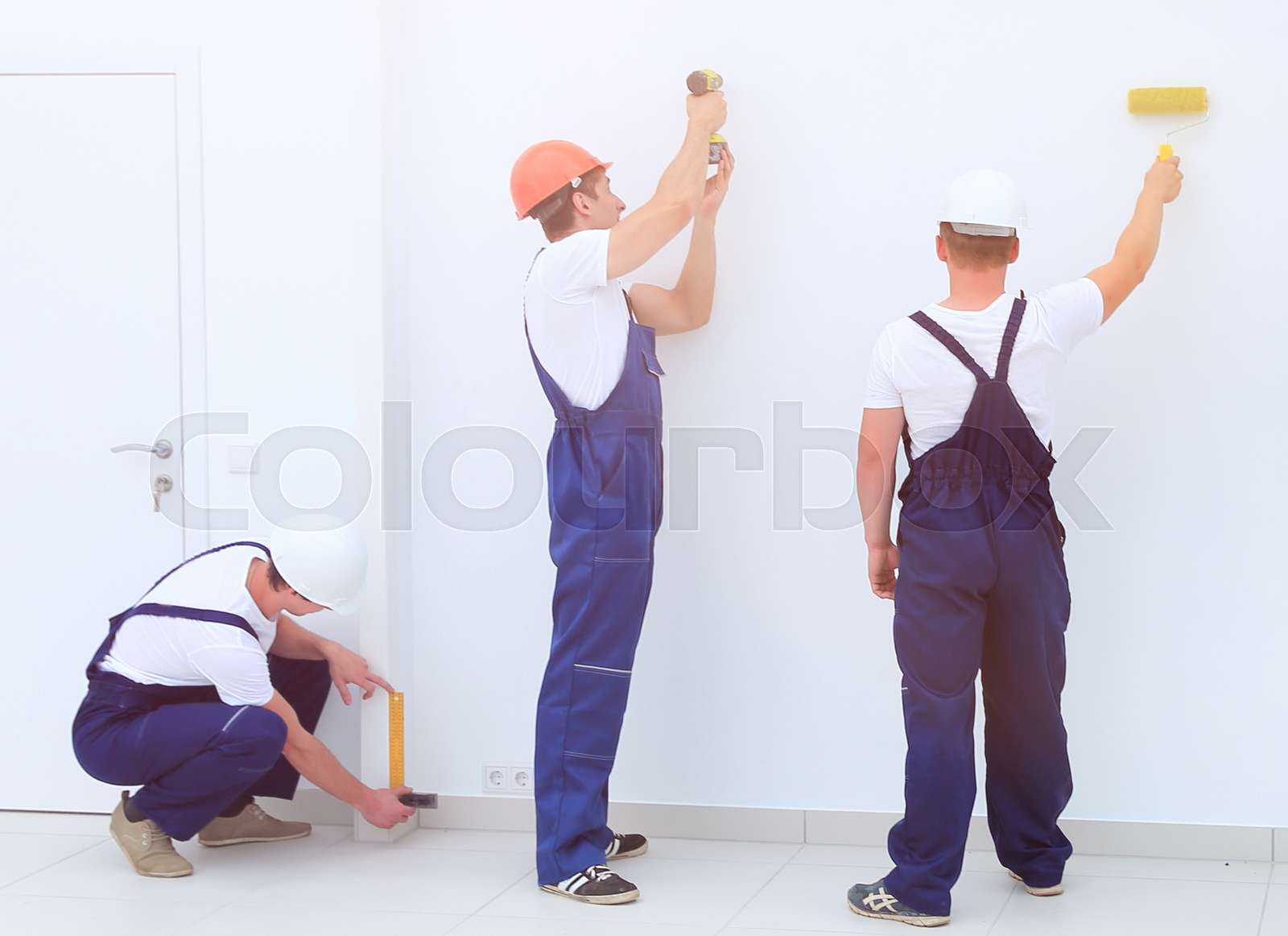 team of builders finishers work indoors | Stock image | Colourbox