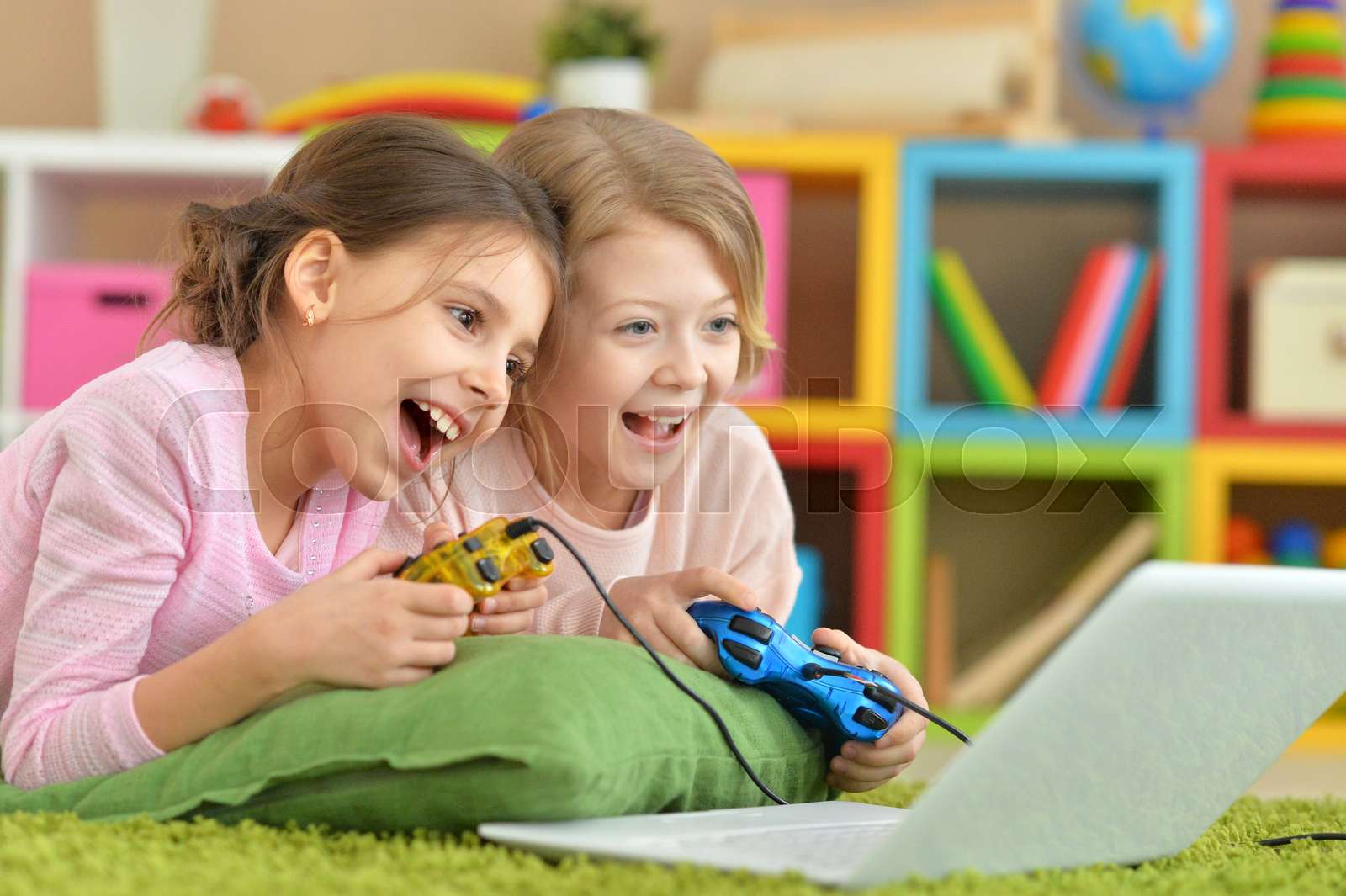 little girls playing computer game | Stock image | Colourbox