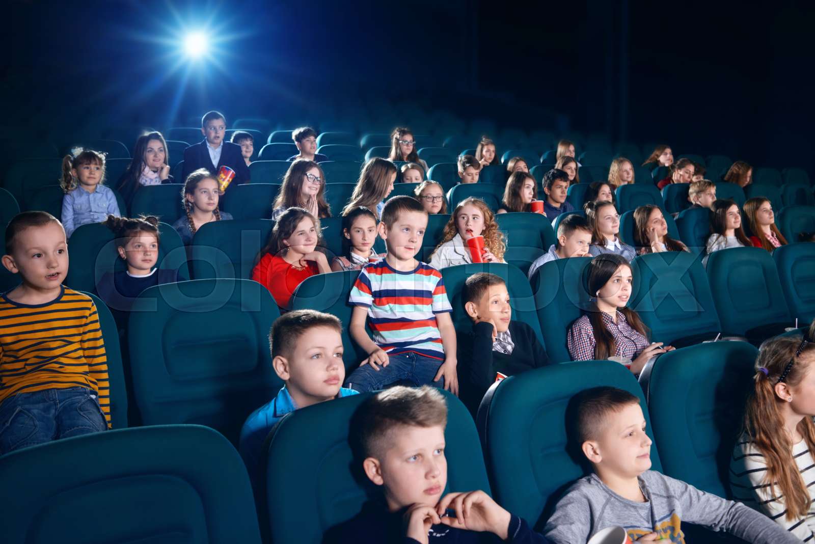 Sideview of people watching movie in the cinema hall. | Stock image ...