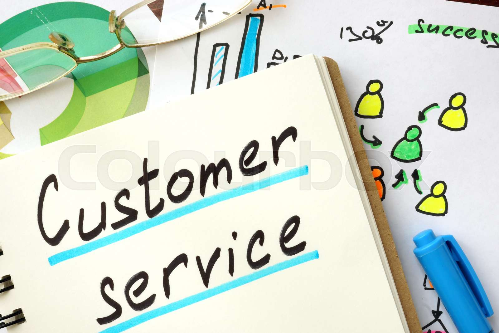 Customer service sign written in a notepad. | Stock image | Colourbox