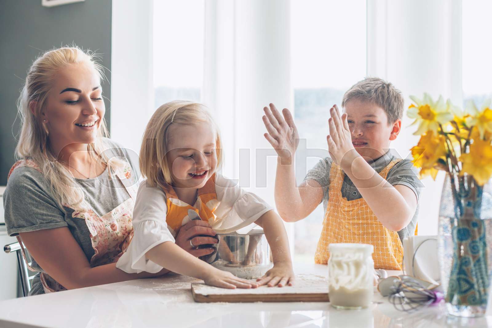 Mom cooking with kids on the kitchen | Stock image | Colourbox