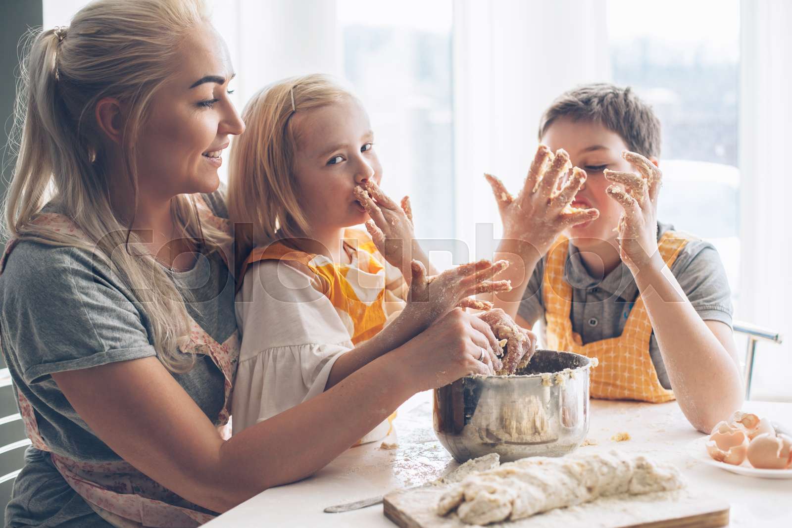 Mom cooking with kids on the kitchen | Stock image | Colourbox