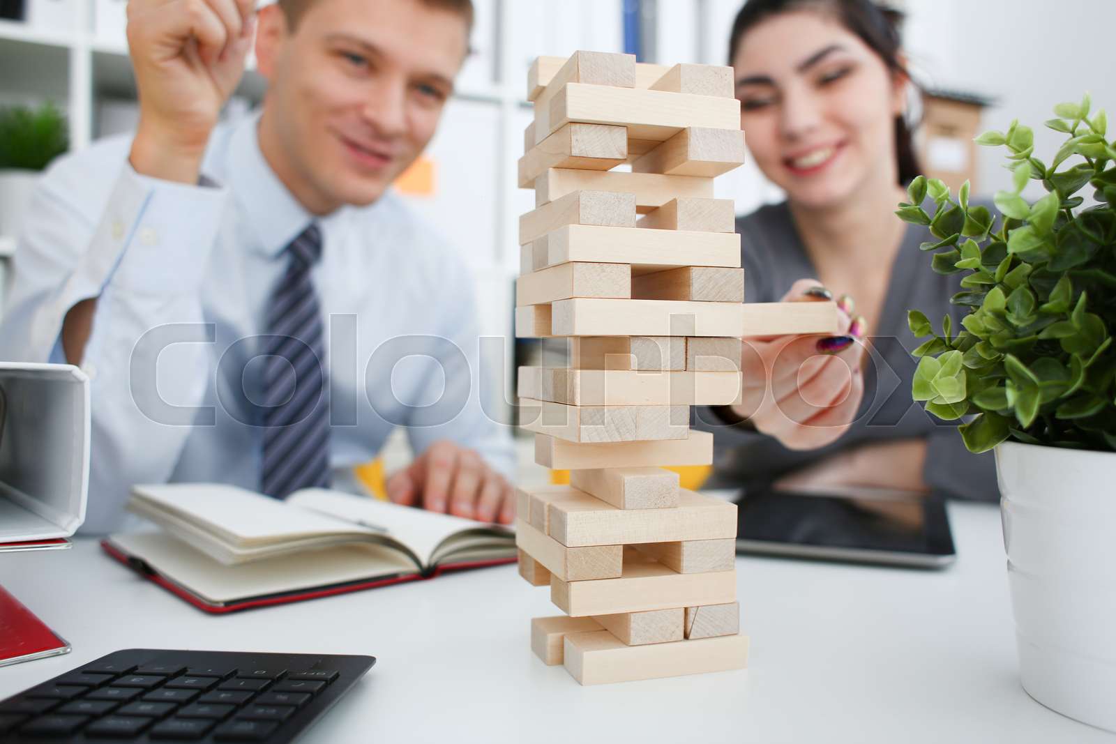 Businessman plays in a strategy of jenga hand | Stock image | Colourbox