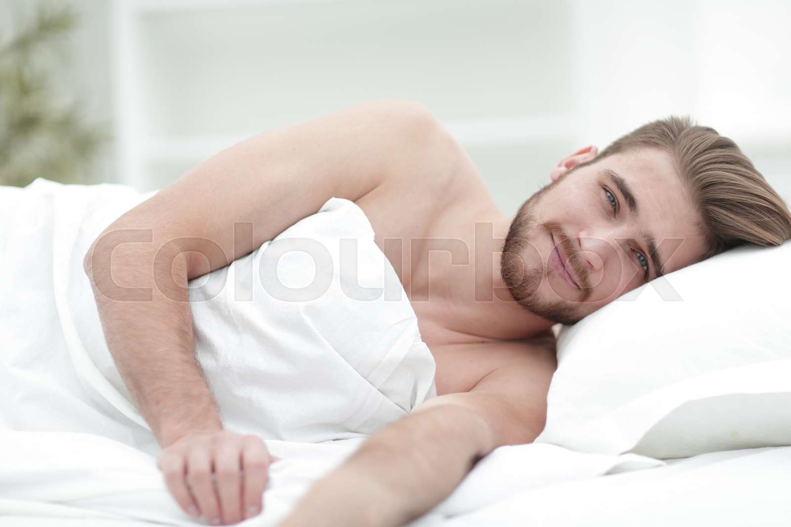 happy man, falling asleep in a comfortable bed | Stock image | Colourbox