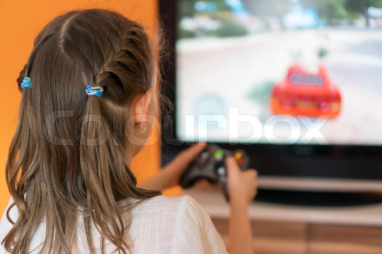 Little girl playing computer game with a joystick. | Stock image ...