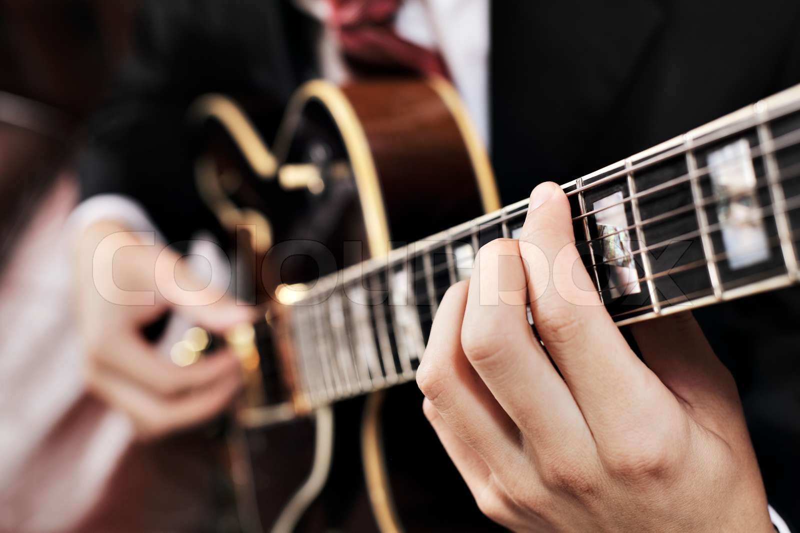 Jazz musician playing with electric guitar Short depth-of-field | Stock ...
