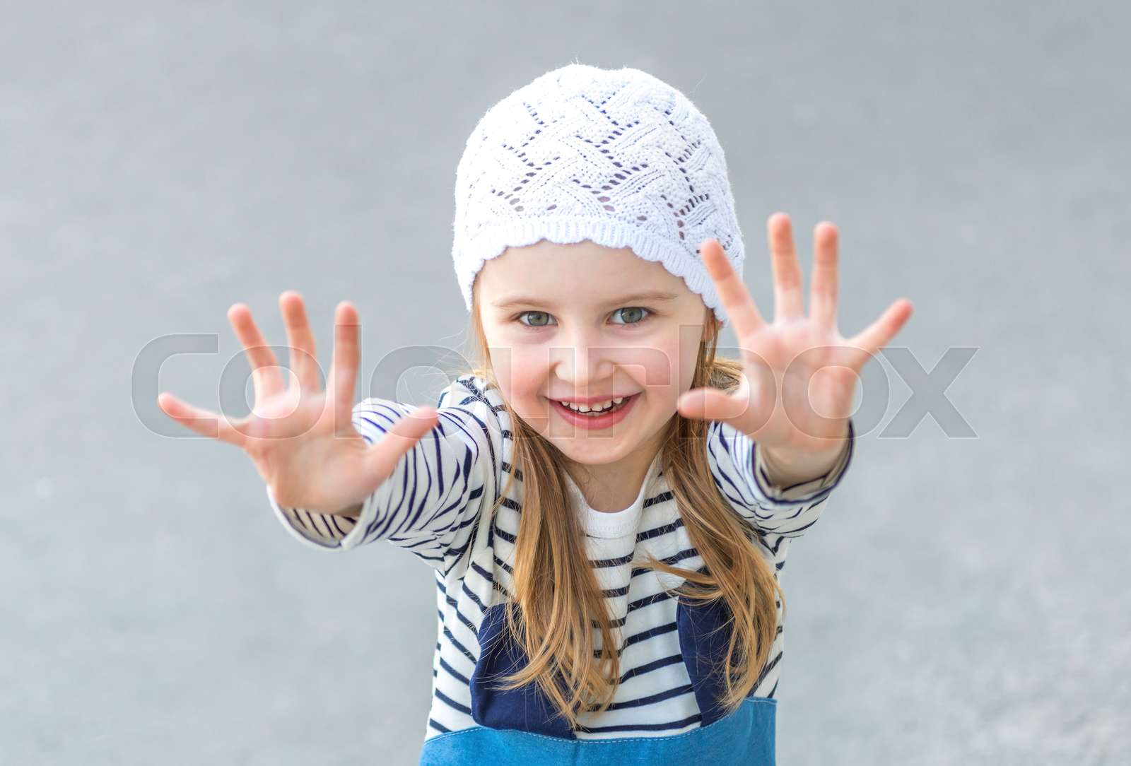 Small child reaching out with her hands | Stock image | Colourbox