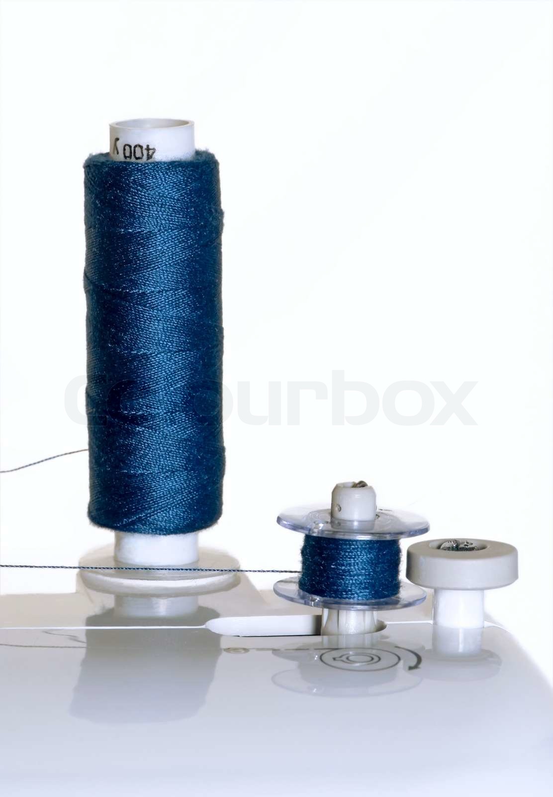 close up of blue bobbins on sewing machine`s thread mechanism | Stock ...
