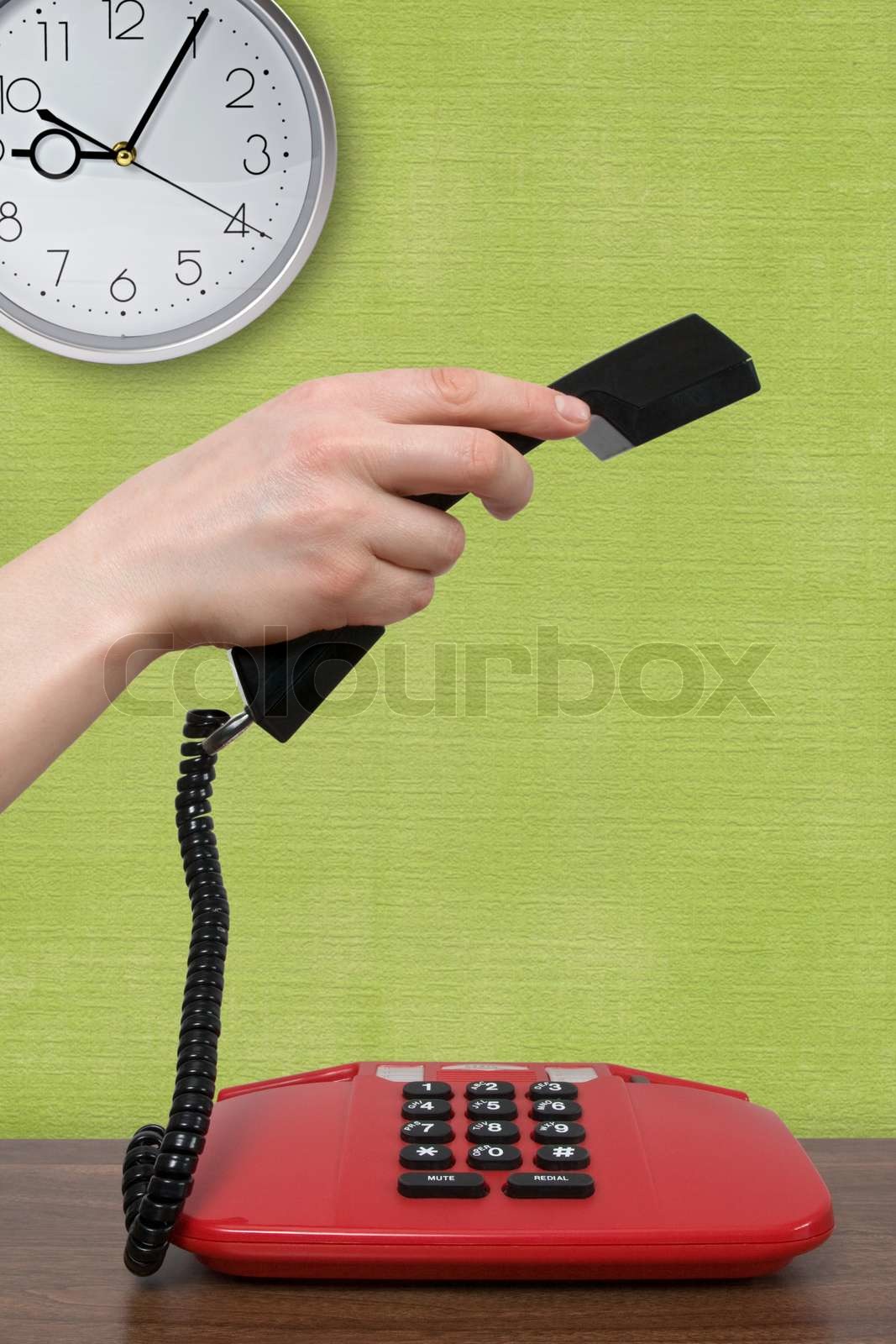making a phone call at nine o'clock in | Stock image | Colourbox