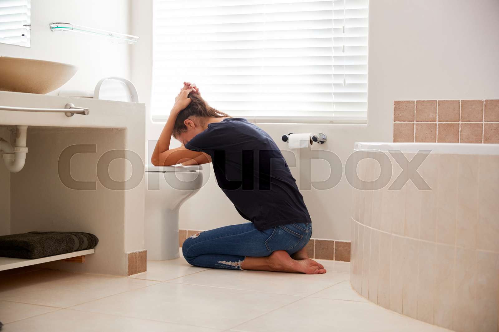 Woman Suffering With Morning Sickness In Bathroom At Home | Stock image ...