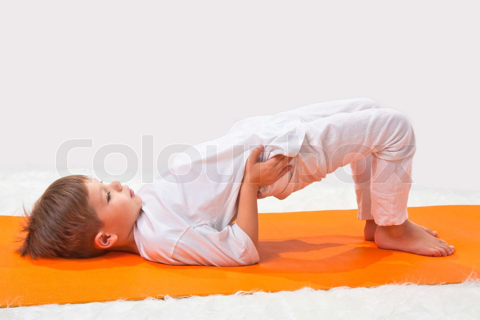The little boy does exercise | Stock image | Colourbox
