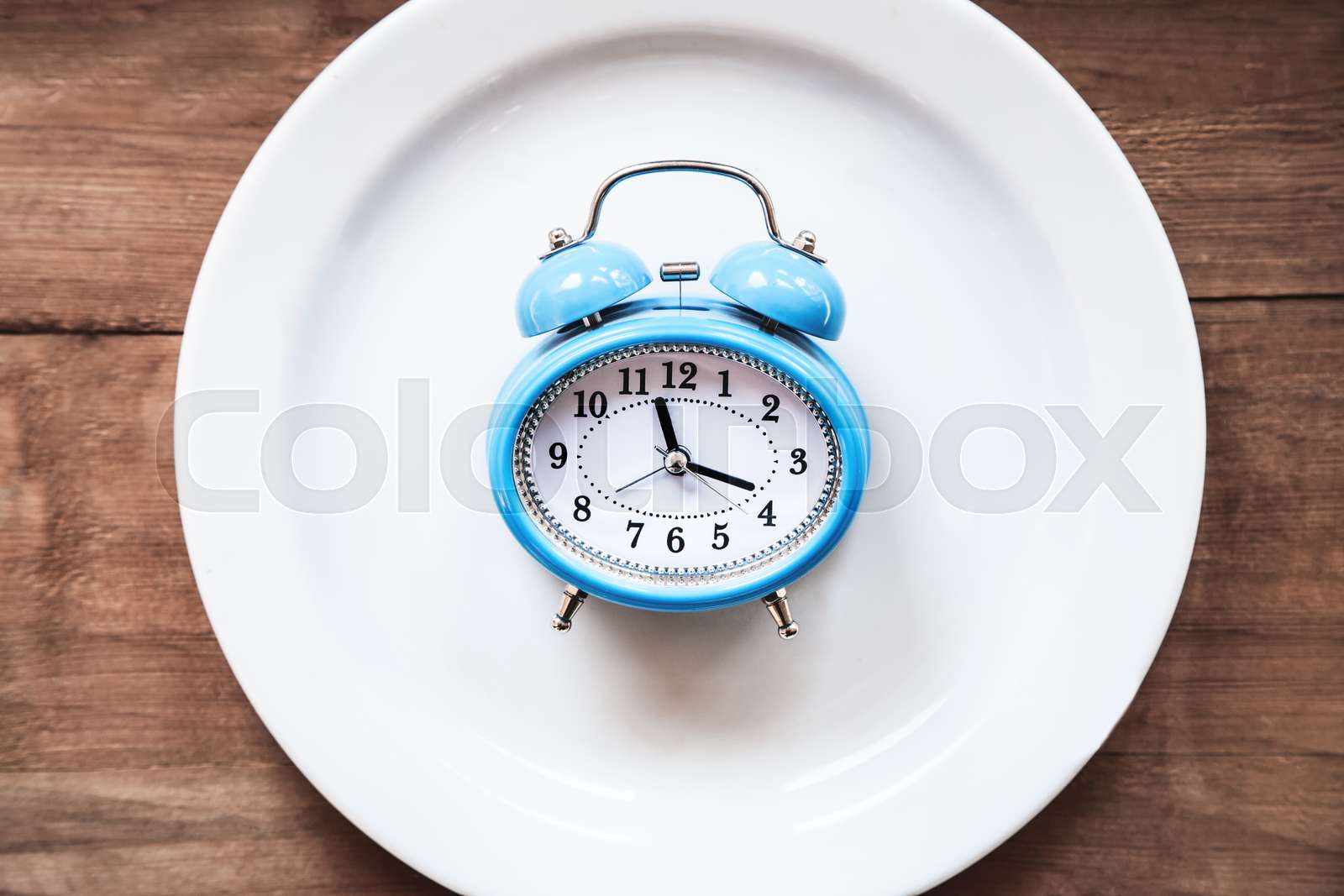 Alarm clock in the plate. Time to eat. | Stock image | Colourbox
