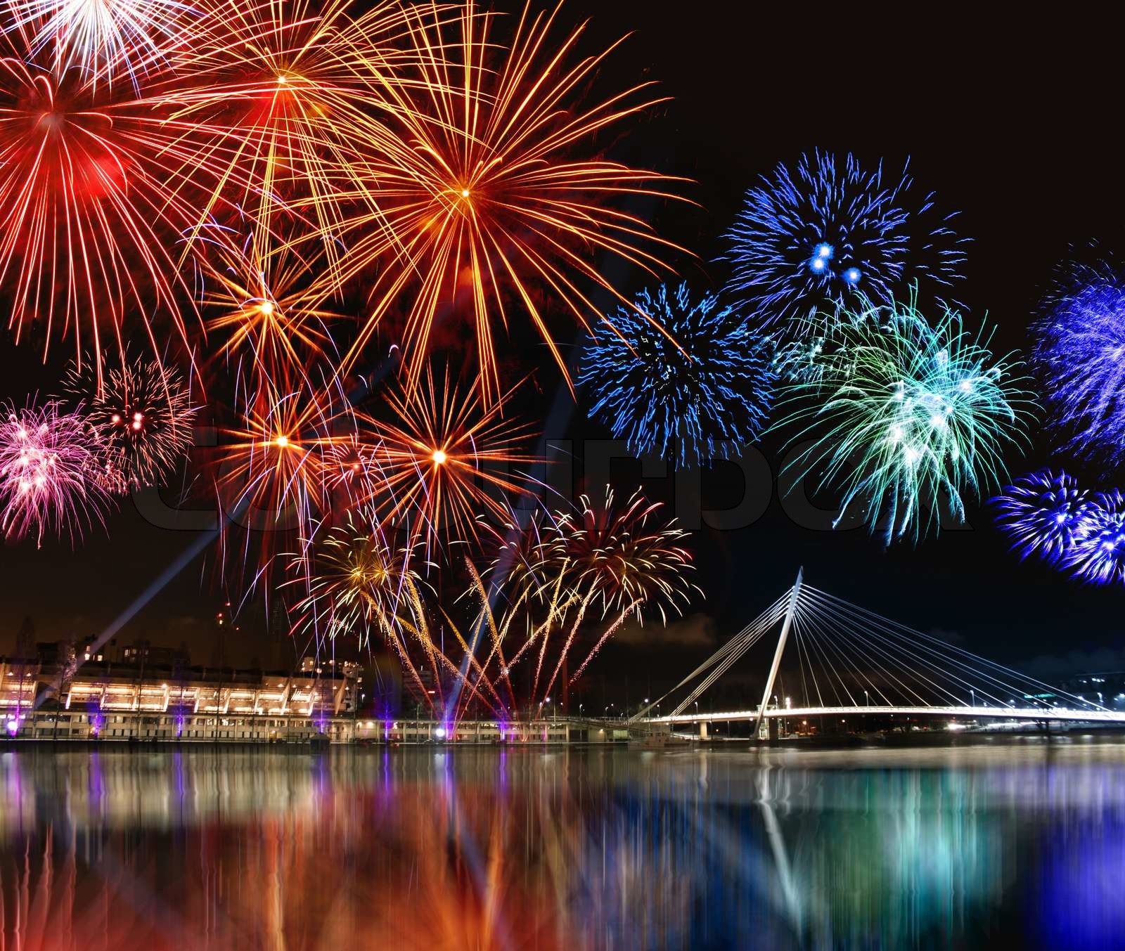 Colorful fireworks reflect from water, | Stock image | Colourbox