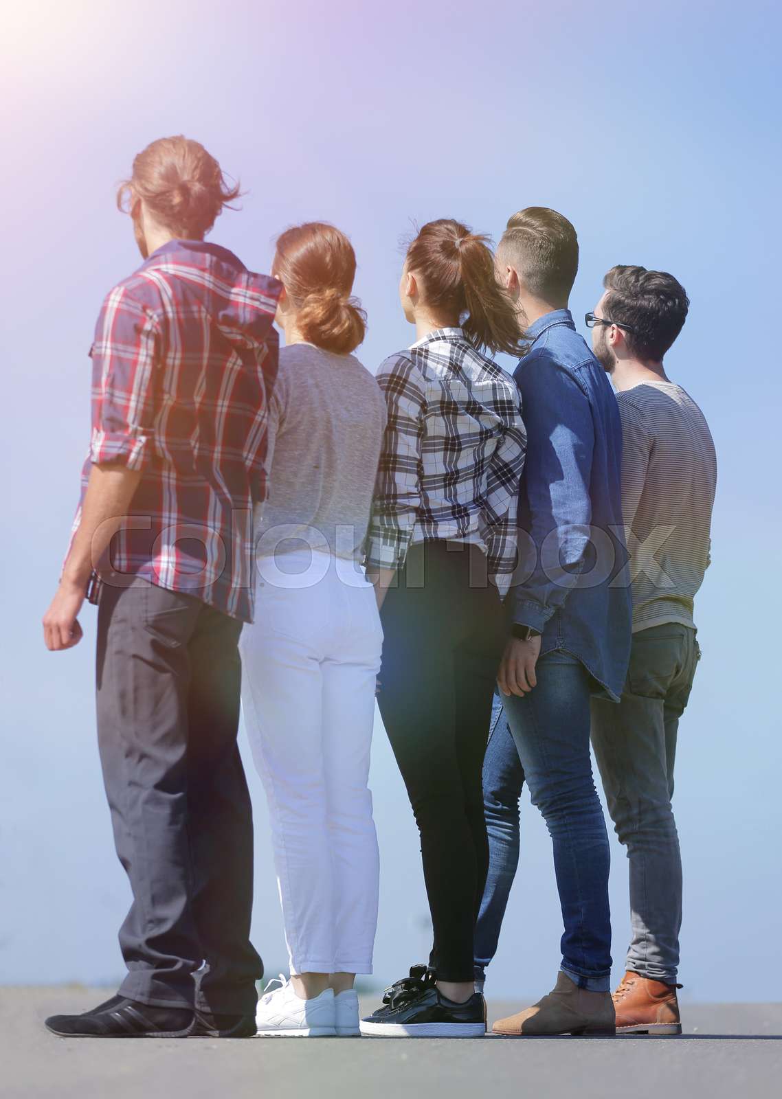 side view.a group of young people looking at copy space | Stock image ...