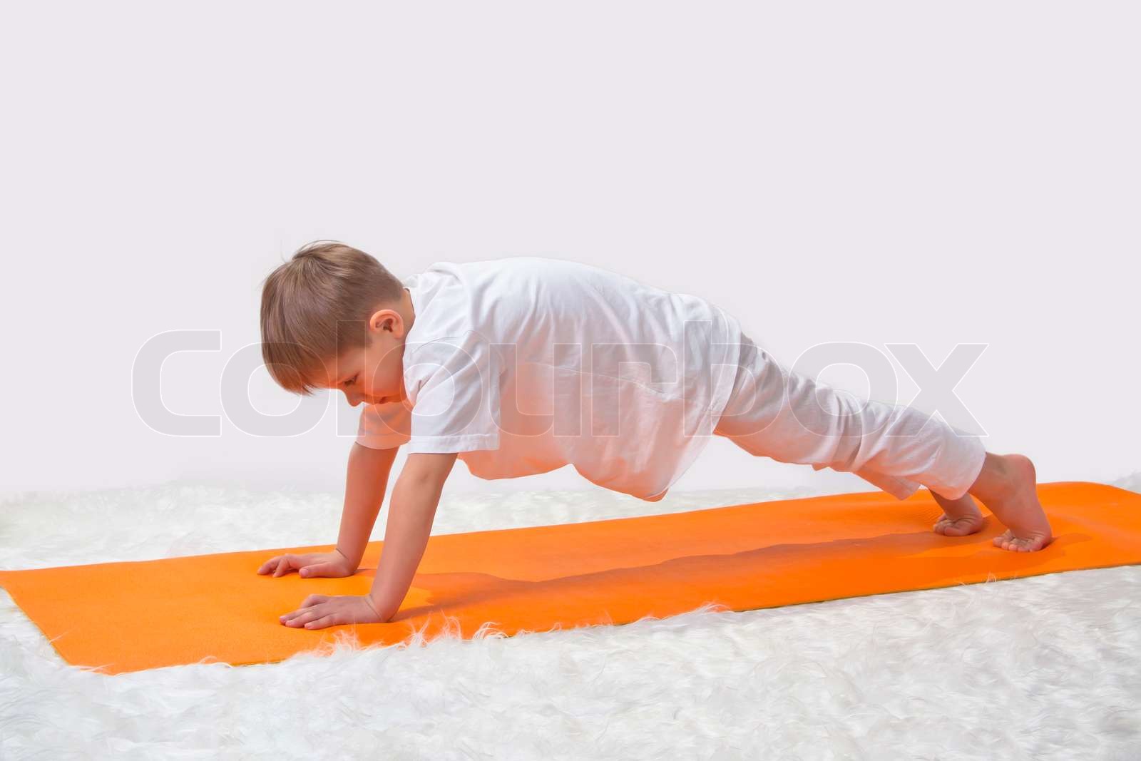 The little boy does exercise | Stock image | Colourbox