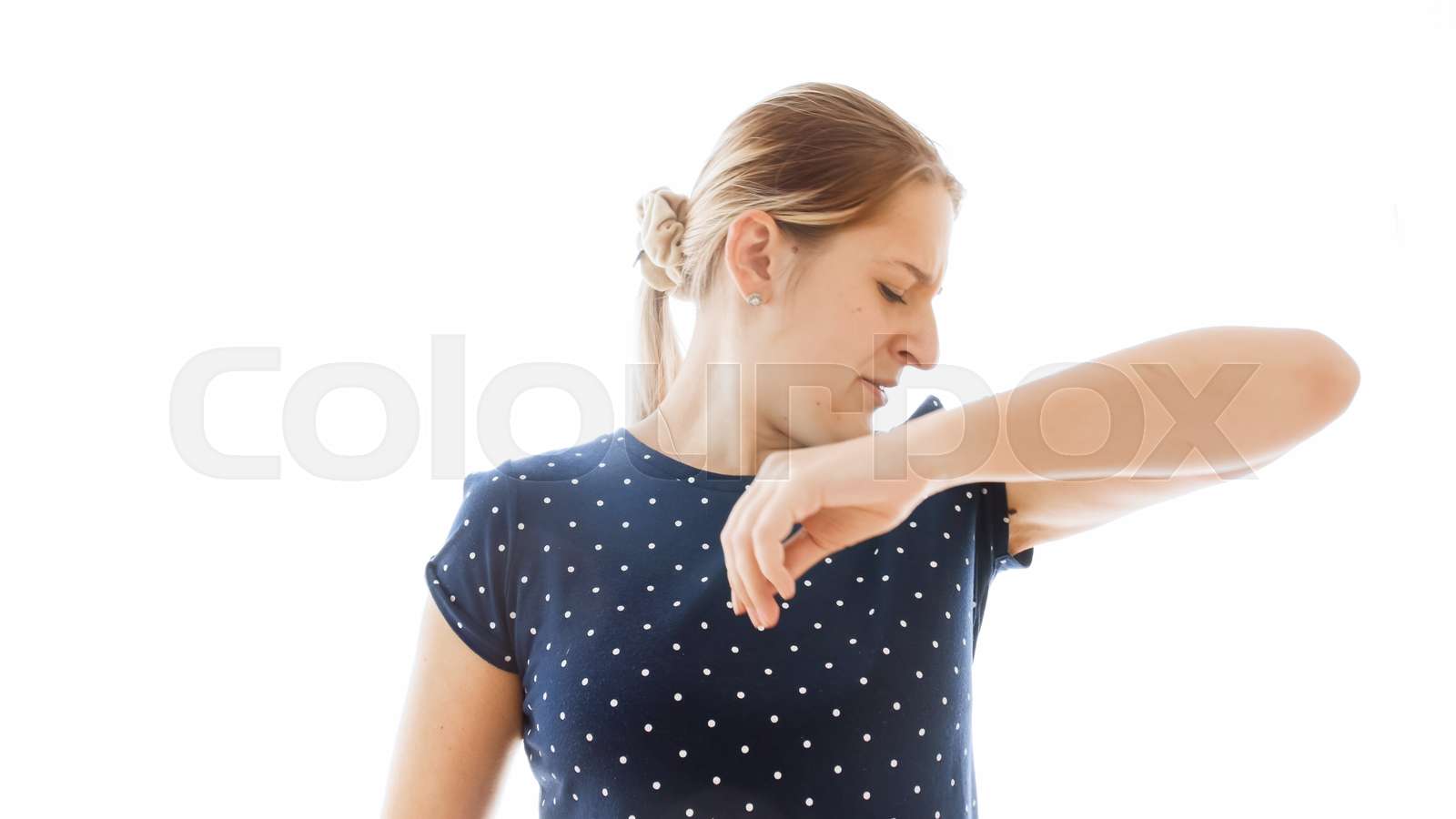 Portrait of young woman smelling under her armpits | Stock image ...