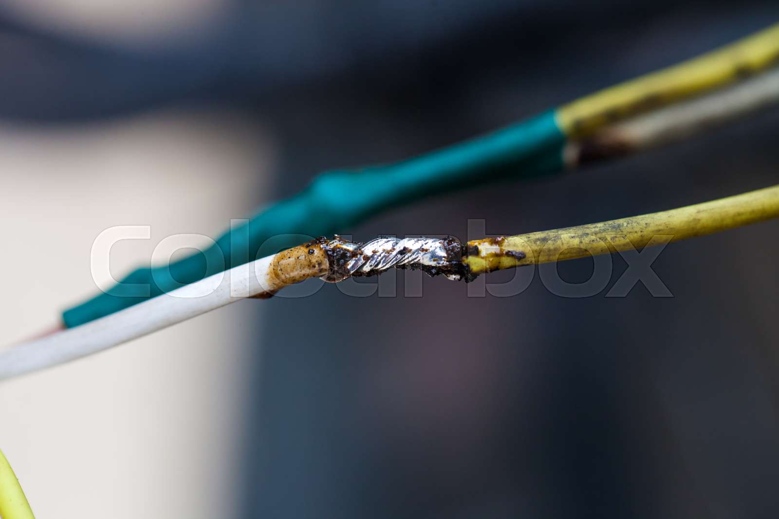 Closeup of exposed live electrical wire with melted insulation ...