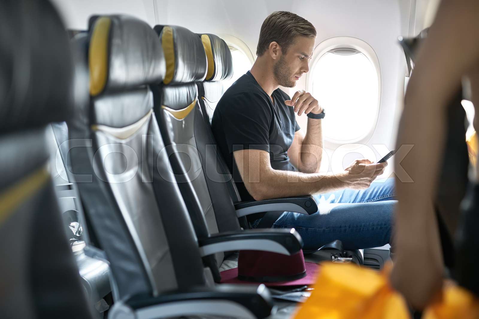 Handsome guy in airplane | Stock image | Colourbox