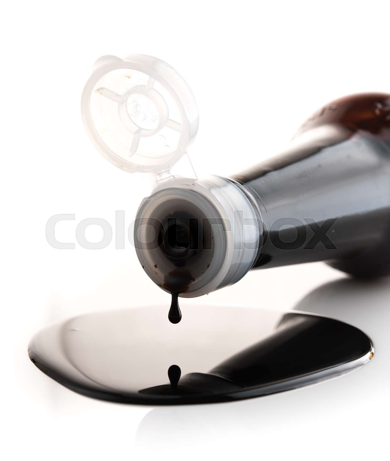 Spilled soy sauce from bottle isolated on white | Stock image | Colourbox
