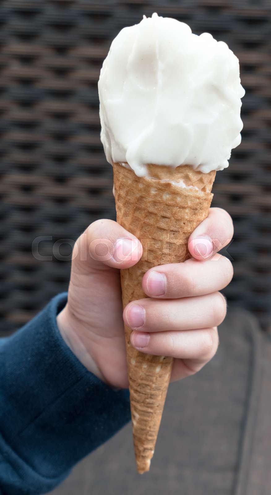 Ice cream in child's hand | Stock image | Colourbox