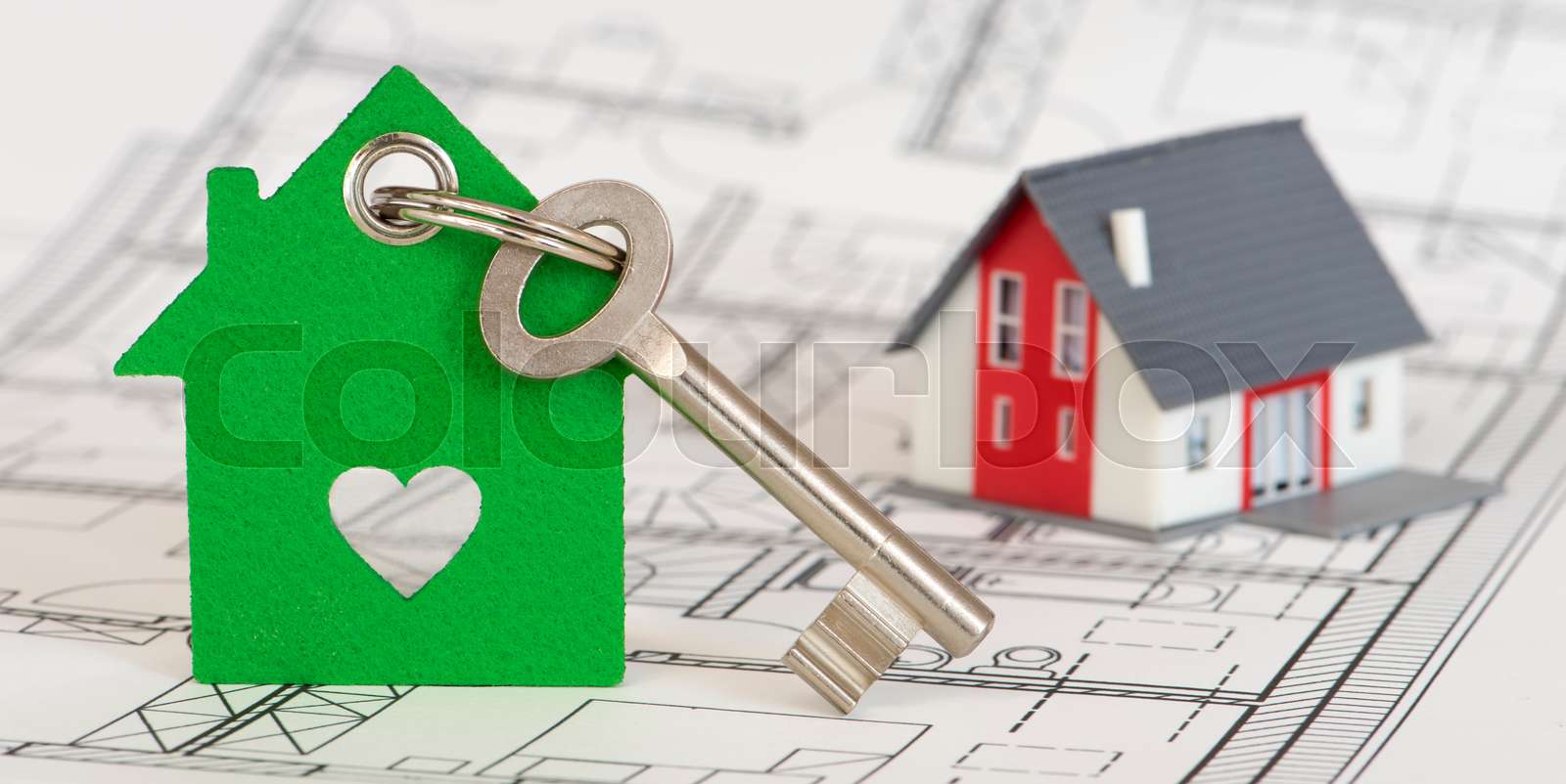 model house and home key laying over construction plan | Stock image ...