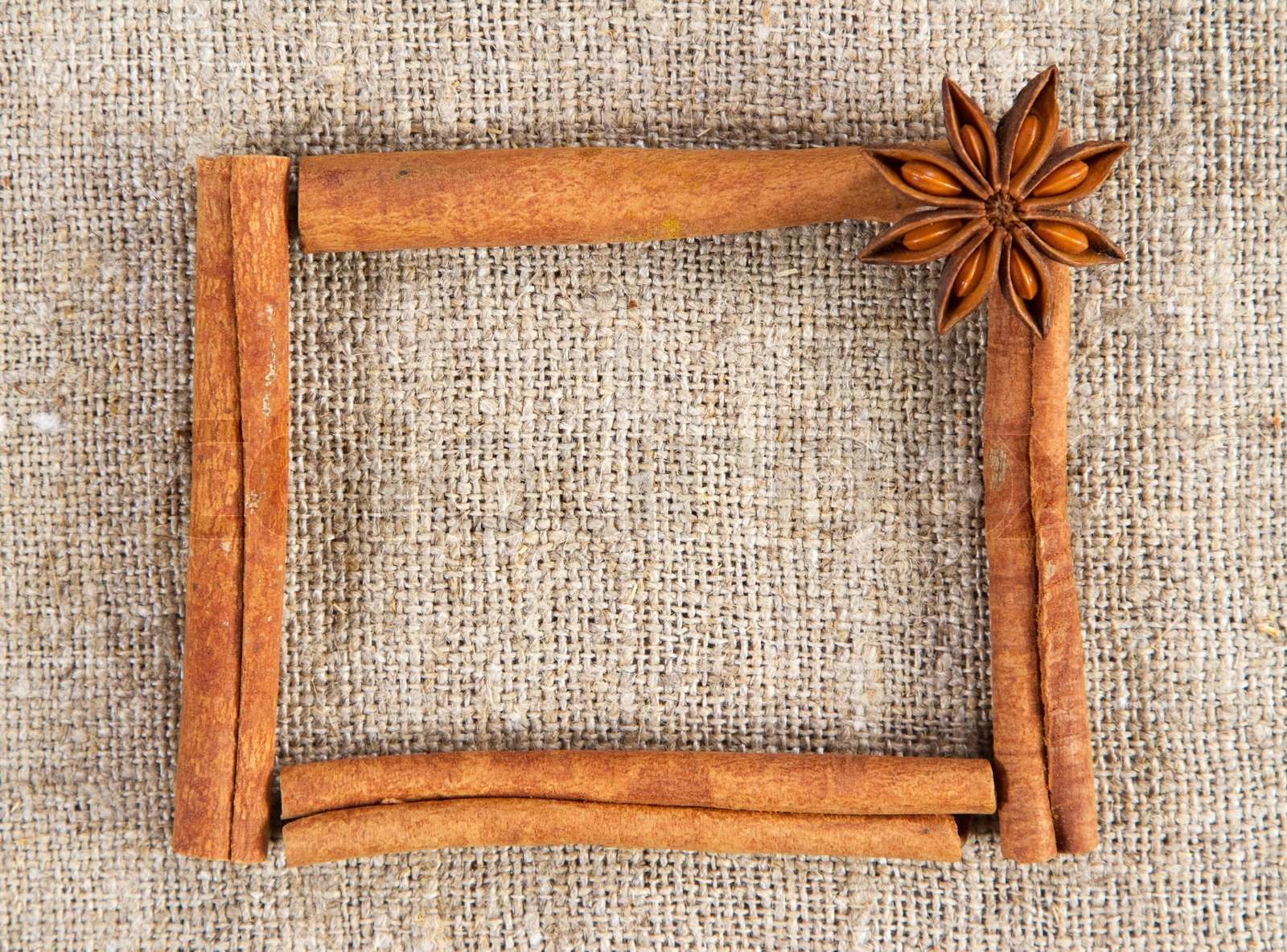 Cinnamon sticks frame on a sacking cloth | Stock image | Colourbox