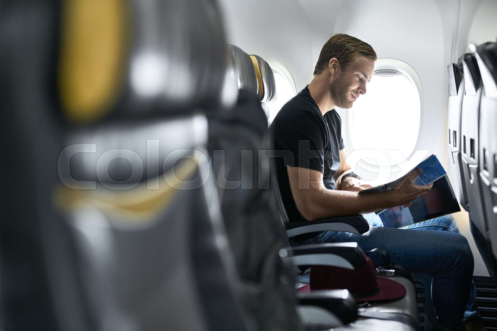 Handsome guy in airplane | Stock image | Colourbox
