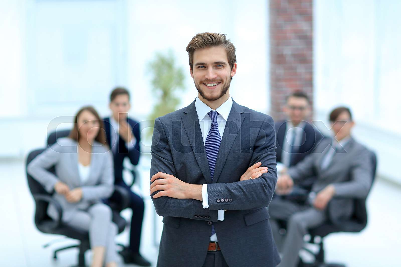 Successful businessman at the office leading a group | Stock image ...