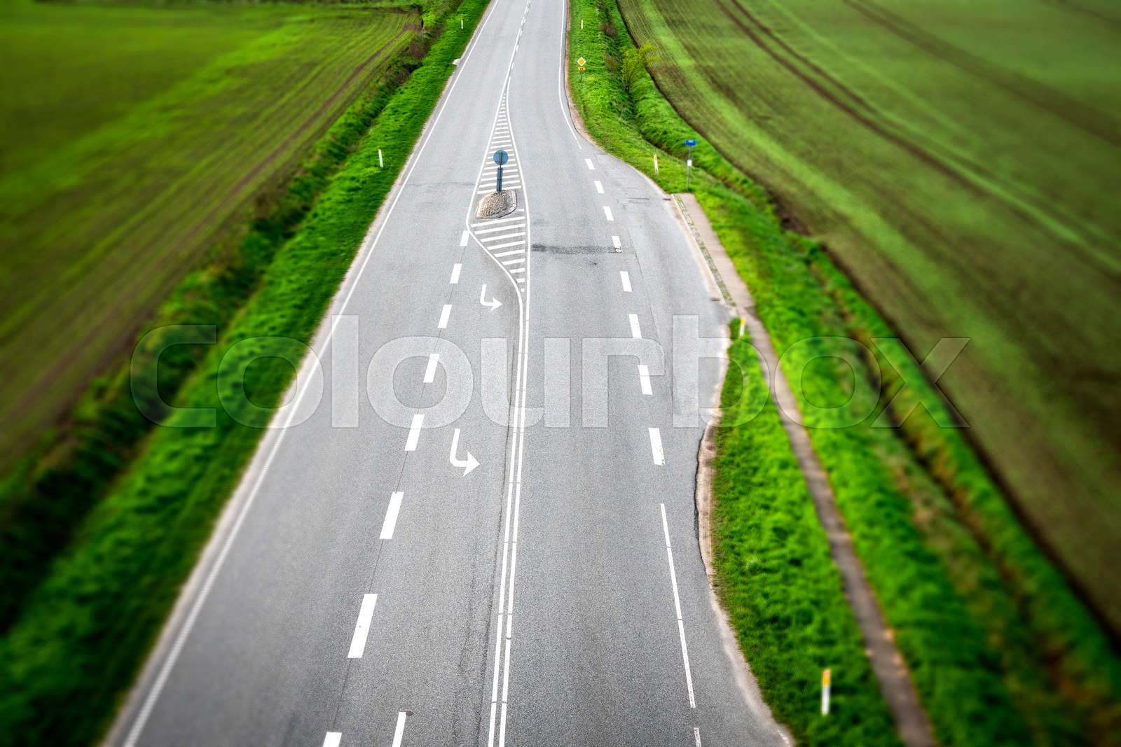 Highway road with white stripes with rural fields | Stock image | Colourbox