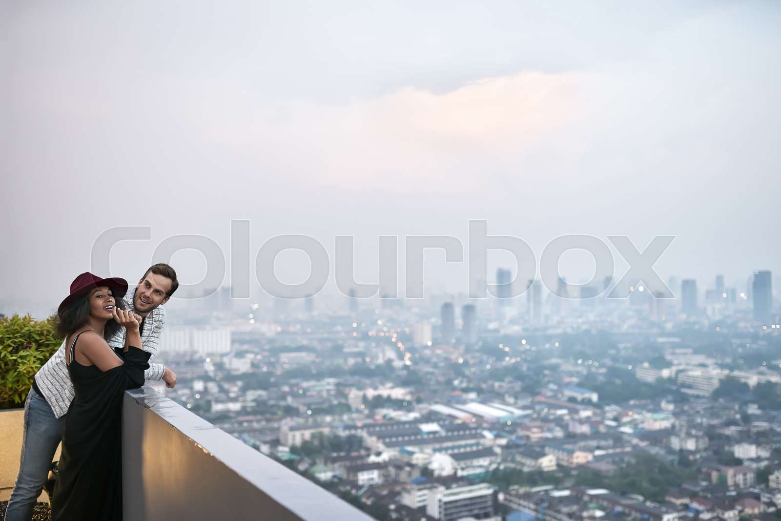 Lovely interracial couple on balcony | Stock image | Colourbox