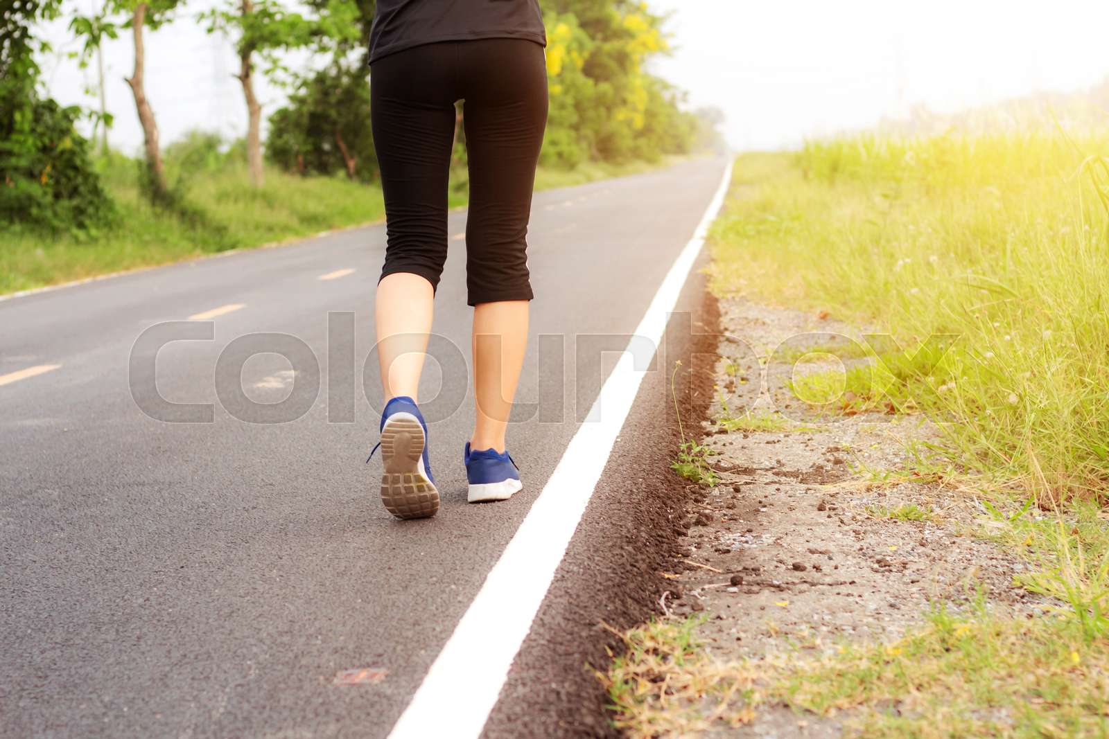 Feet of girl are jogging. | Stock image | Colourbox