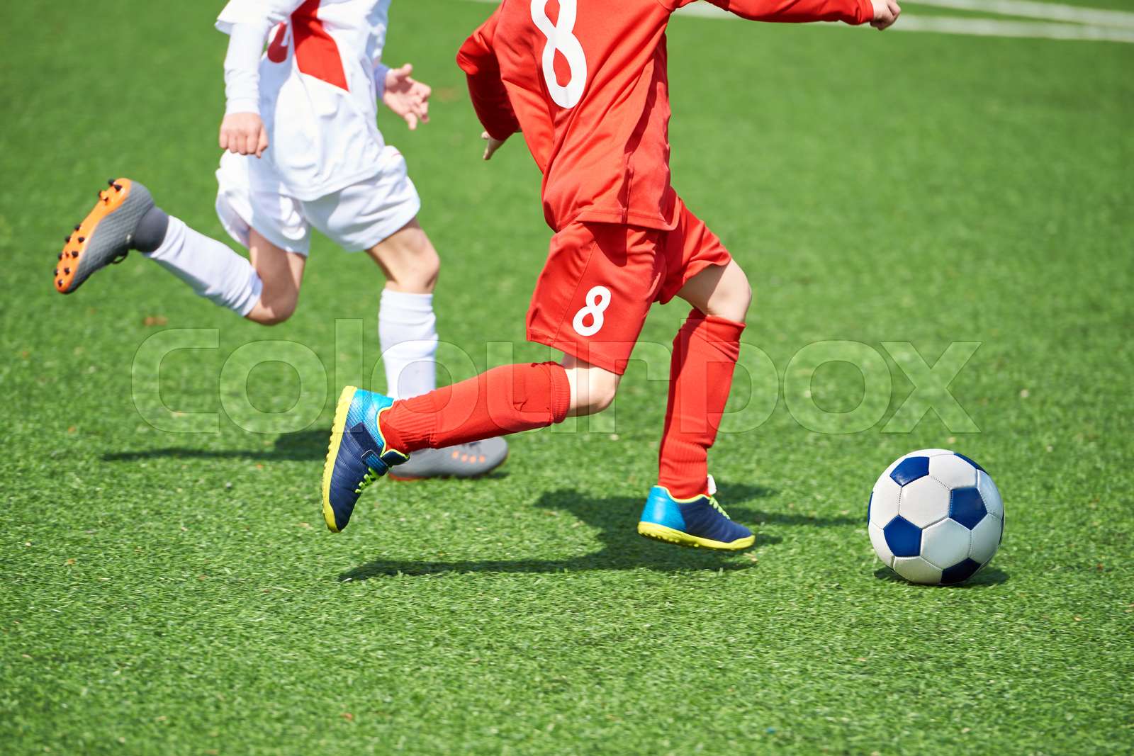 Child football players and ball | Stock image | Colourbox