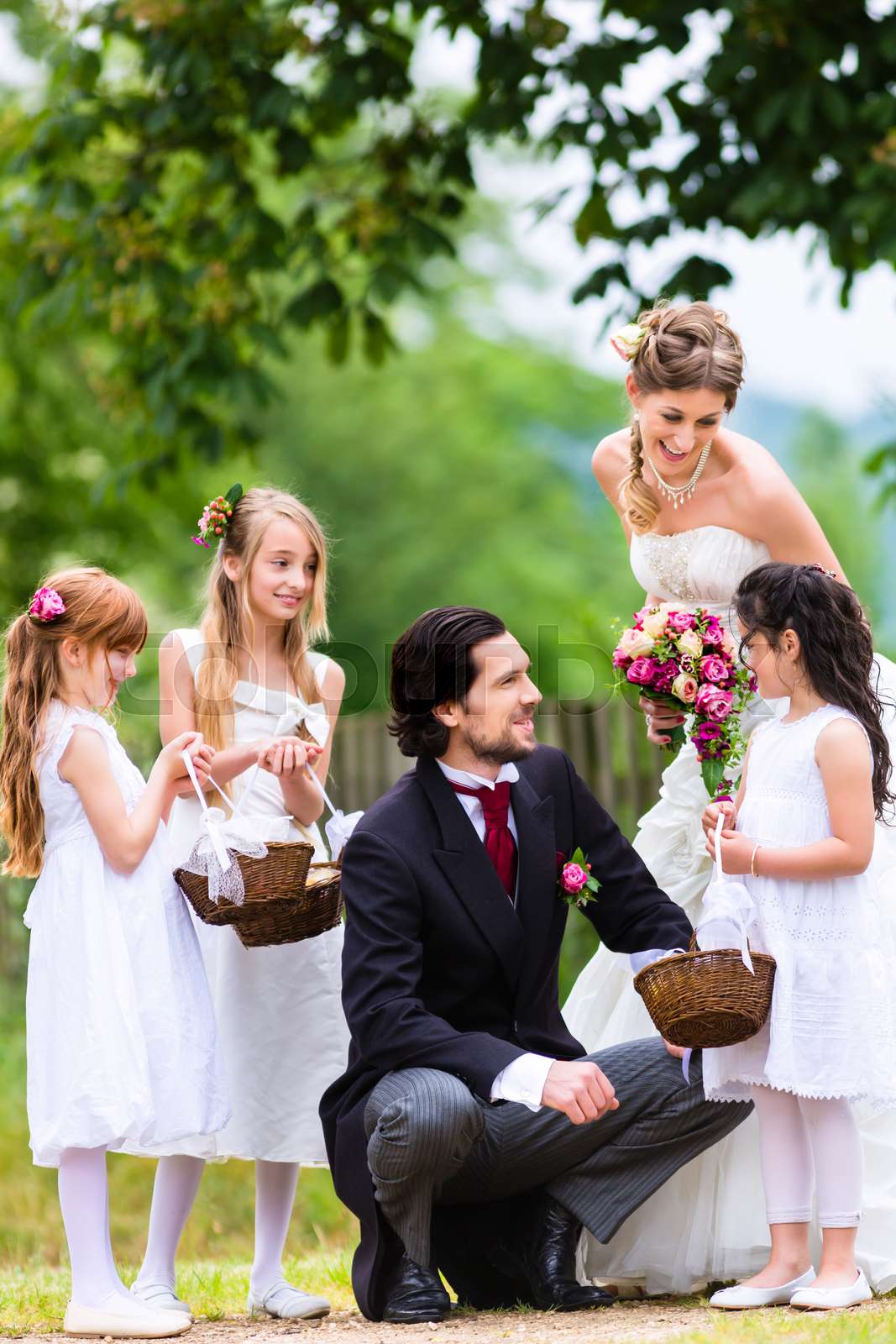 Bridal couple at wedding with bridesmaid children | Stock image | Colourbox