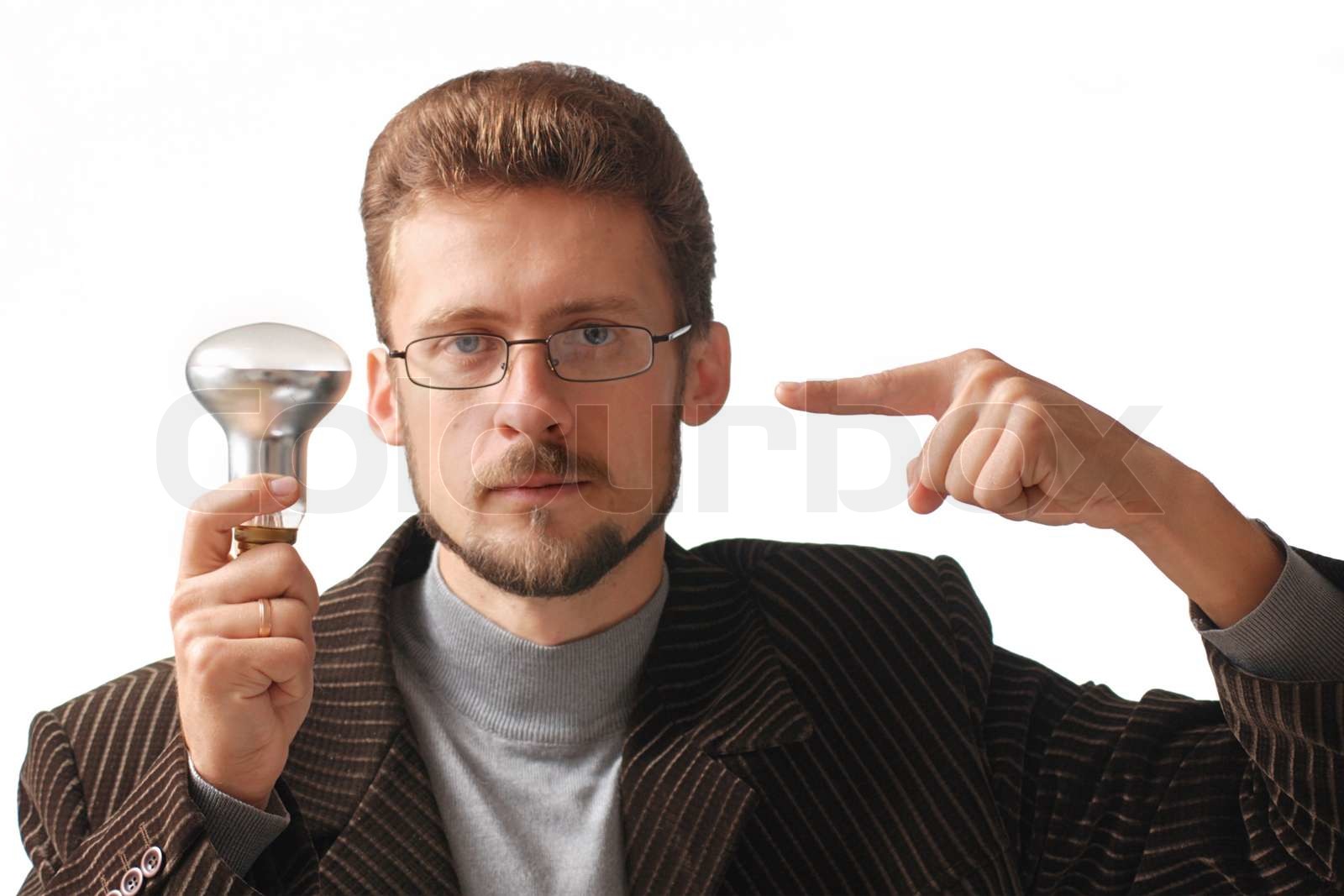 Man pointing onto a lamp | Stock image | Colourbox