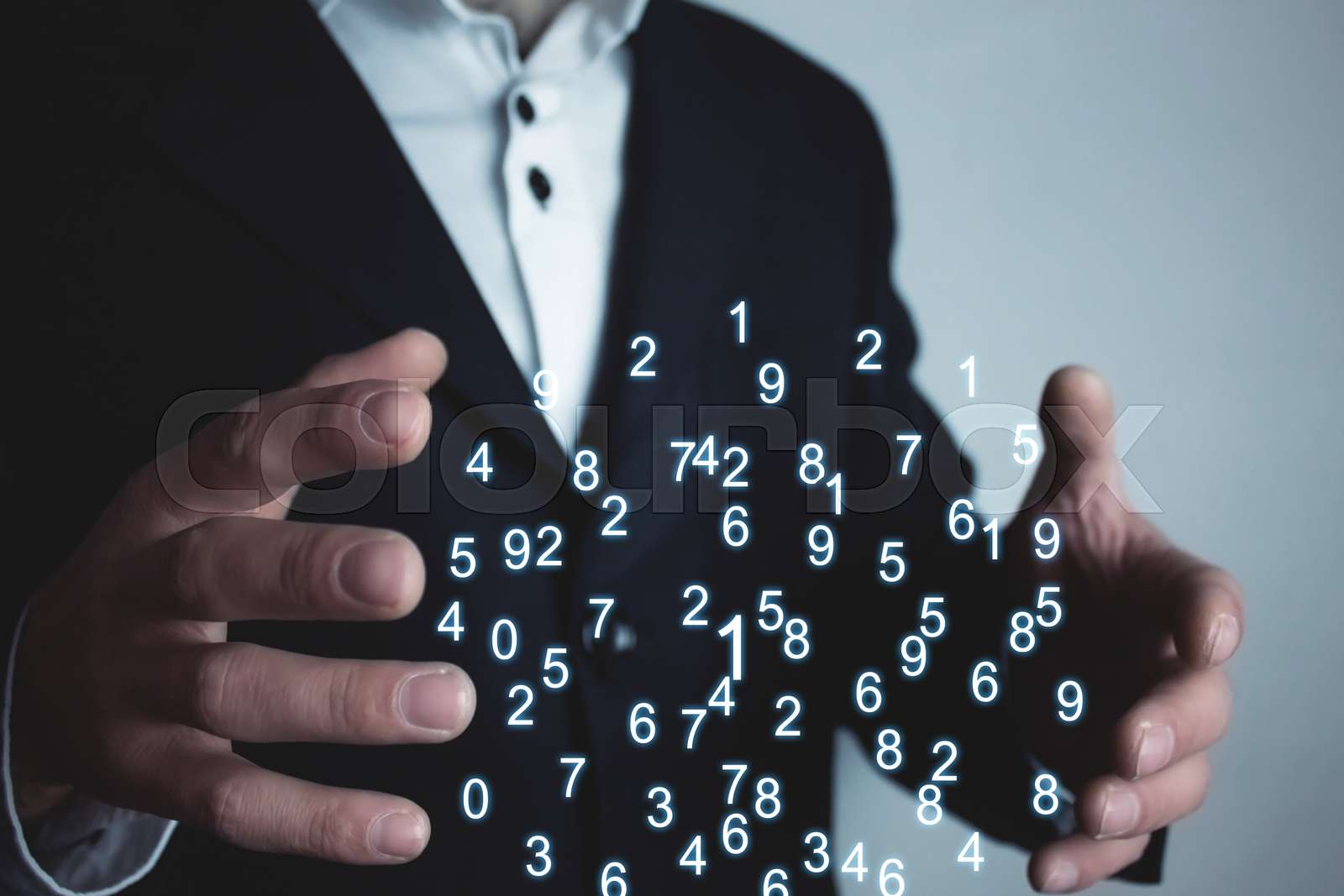Man holding numbers. Digital information concept | Stock image | Colourbox