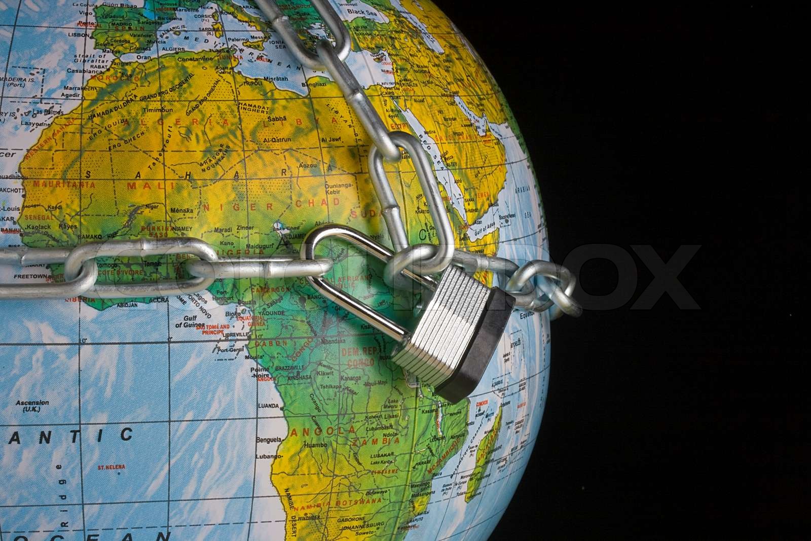 Metal lock and chain on a globe | Stock image | Colourbox