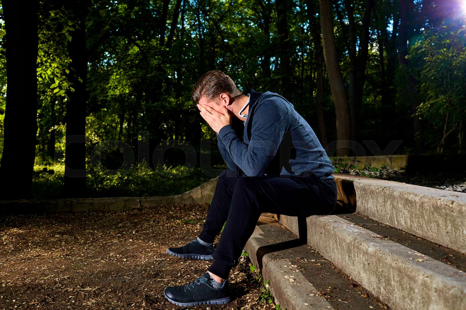 Defeat concept. The defeated sportsman covered his face with his hands ...