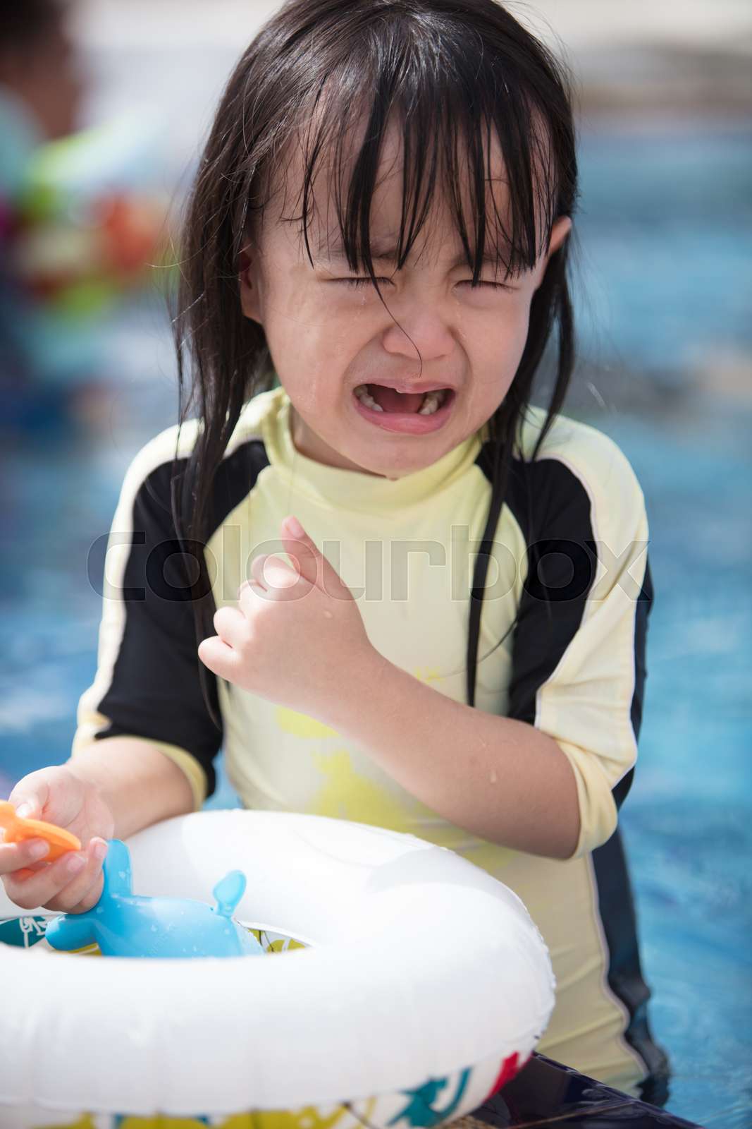 Asian Little Chinese Girl crying in Swimming Pool | Stock image | Colourbox