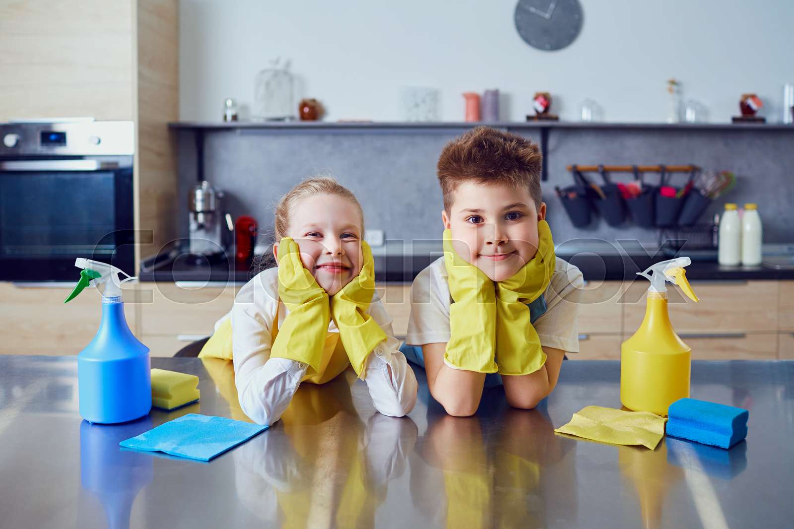 Smiling children do the cleaning in the kitchen | Stock image | Colourbox