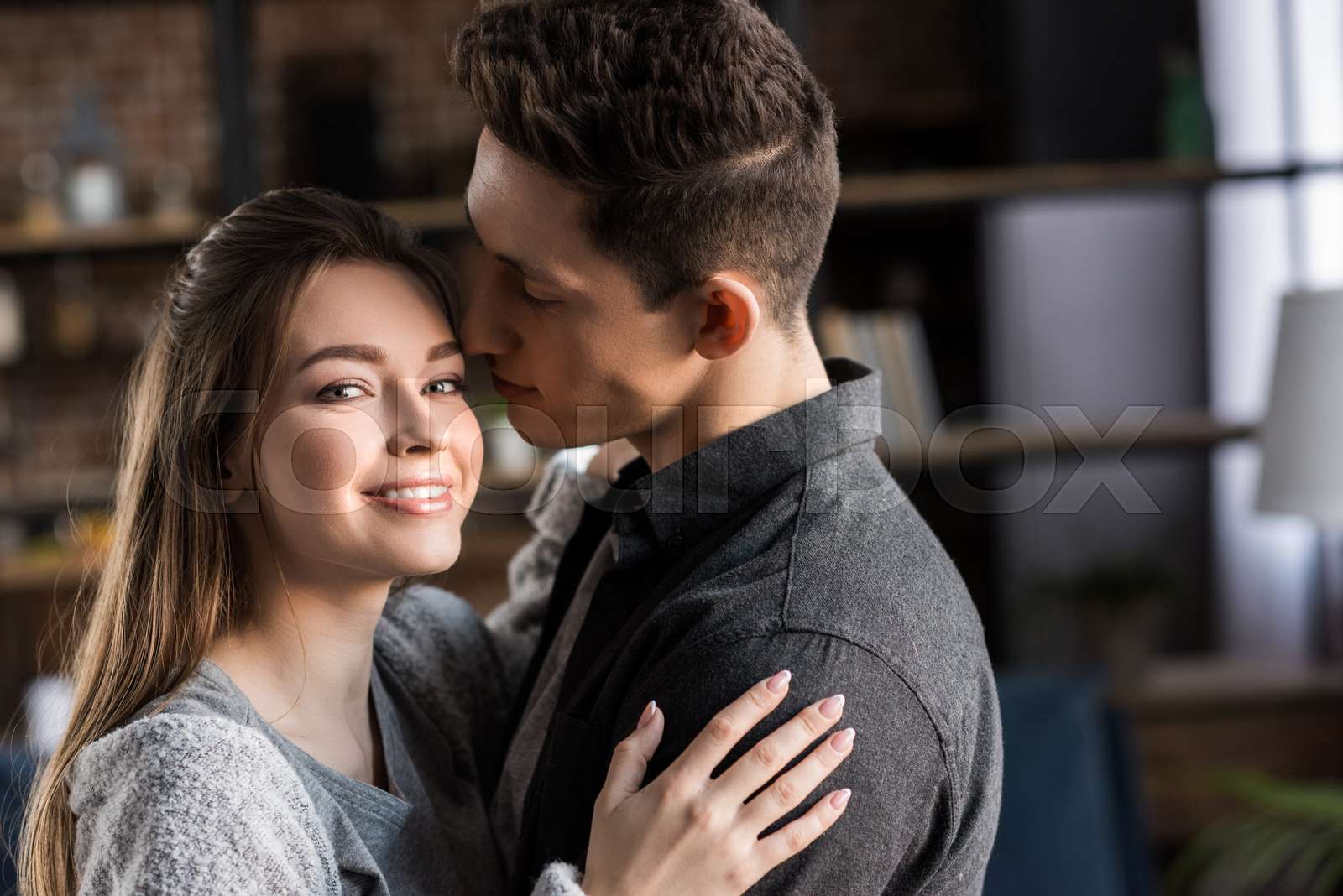 boyfriend kissing girlfriend and she looking at camera | Stock image ...